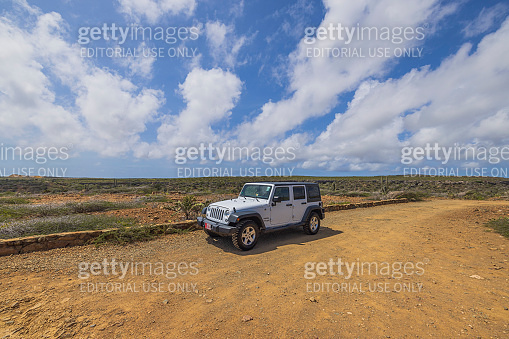 Beautiful view of white jeep wrangler in desert on road of National ...