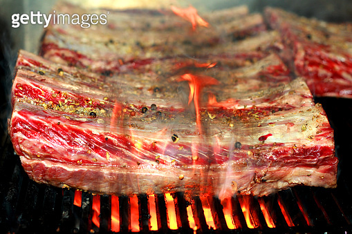 spice marinated american angus beef ribs on a barbecue grill with flame ...