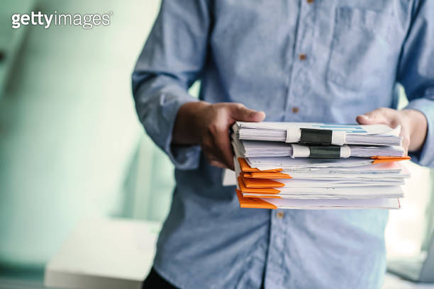Close up businessman holding stack of business document papers ...
