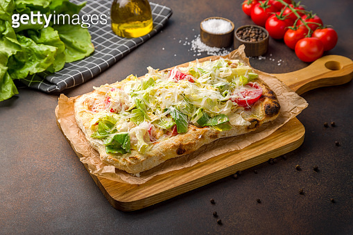 Roman pizza, Pinsa caesar with chicken and salad on roman dough side ...