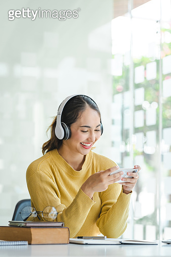 Portrait of a beautiful student viewing and listening video tutorials ...