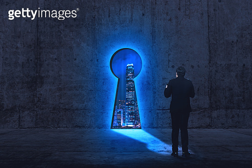 Back view of businessman in front of keyhole opening to city view in ...