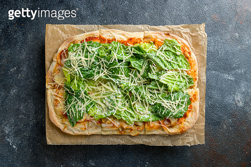 Roman pizza, Pinsa caesar with chicken and salad on roman dough top ...