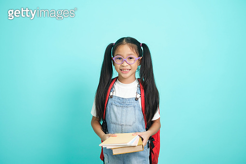 Close-up kid students girl smiling holding book, going to school. 이미지 ...