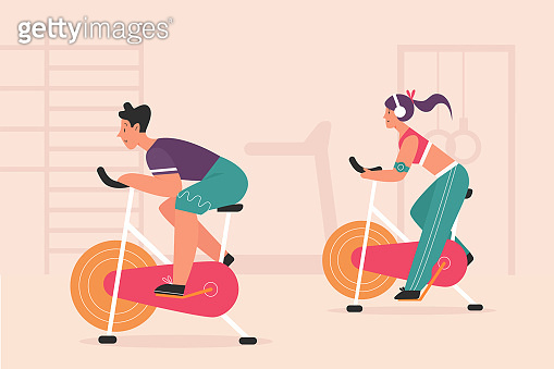 People doing exercises on static stationary bikes in gym of sport club ...