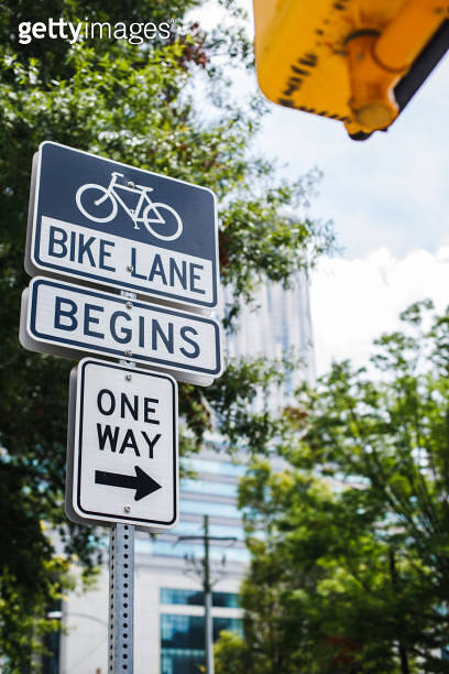 Street signs that say ''Bike lane begins'' and ''One way'' 이미지 ...