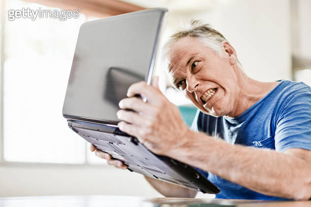 Computer trouble: Middle-aged man contorts his face as he rages against ...