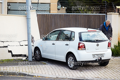 Man beside car in aftermath of traffic accident that damaged the ...