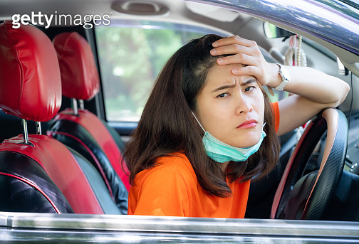Young Asian woman having headache and dizziness while driving car ...
