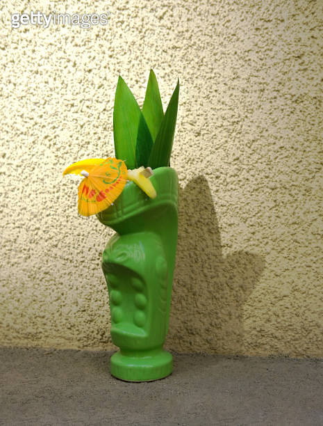 Tiki Monkey cocktail in green ceramic tiki drink glass against the ...