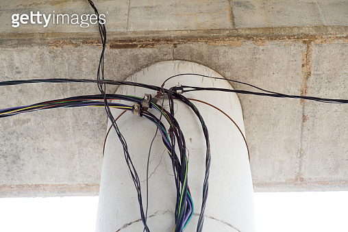 Electrical cable on top of the reinforced concrete bridge support ...