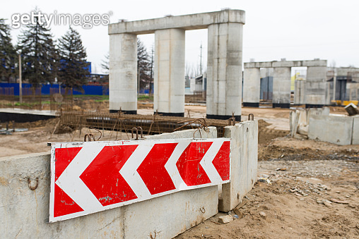 Red arrow pointer on a construction site against the background of ...