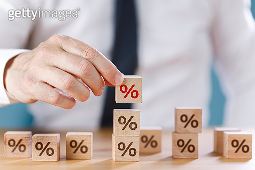 Businessman stacking wooden cubes block which printed screen percentage ...