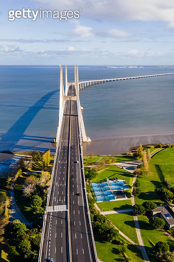 Aerial view of Vasco da Gama bridge crossing the Tagus River on a sunny ...