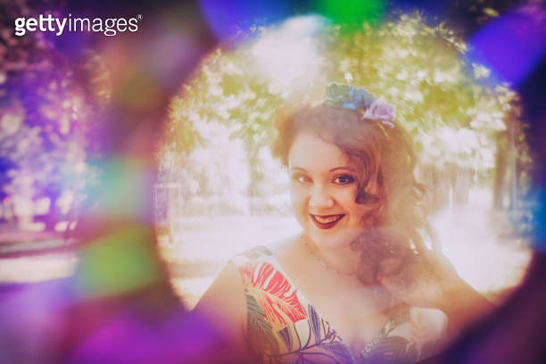 Young woman headshot portrait in rainbow frame, looking at camera and ...