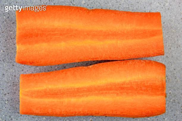 Natural fresh carrots halved in the into two parts middle. The texture ...