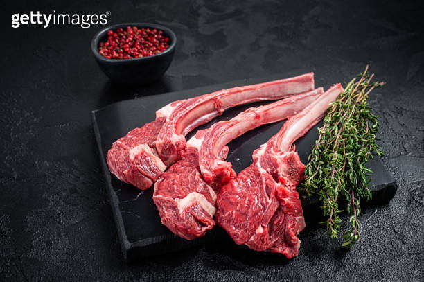Uncooked Raw Lamb chop steak, mutton cutlet on marble board. Black ...