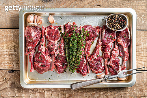 Raw uncooked lamb mutton meat chops steaks with thyme and garlic ...