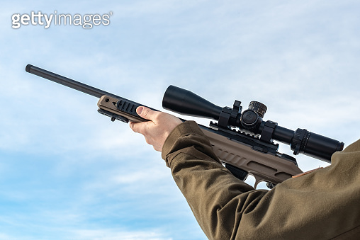 A sniper rifles aim from a rifle with an optical sight in man`s hands ...