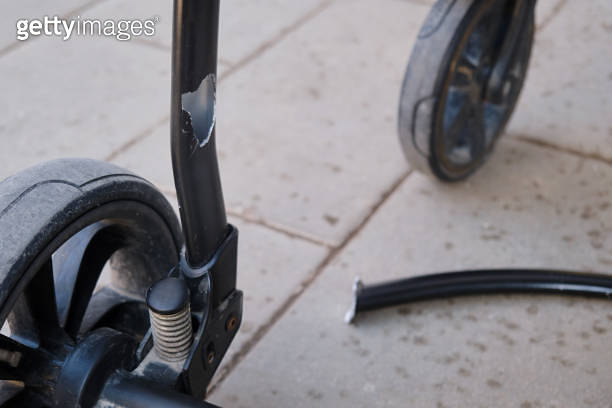 Broken chassis of a baby stroller, damage to the crossbar of the metal ...