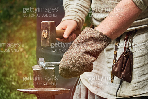 Work of a medieval blacksmith for the manufacture of metal products ...