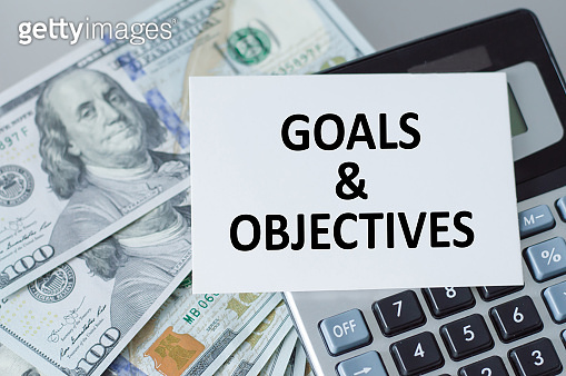 Goals and Objectives, text on a card on the background of the ...