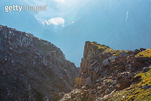 Sunny mountain view from cliff at very high altitude. Scenic alpine ...