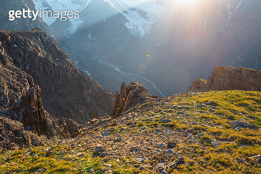 Sunny mountain view from cliff at very high altitude. Scenic alpine ...
