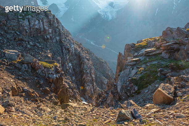 Sunny mountain view from cliff at very high altitude. Scenic alpine ...