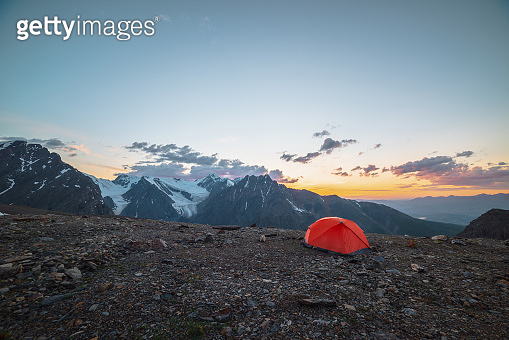Scenic alpine landscape with tent at very high altitude with view to ...