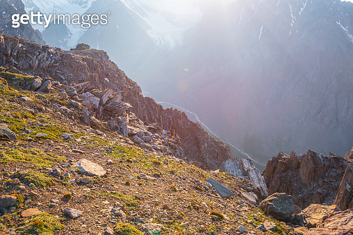 Sunny mountain view from cliff at very high altitude. Scenic alpine ...