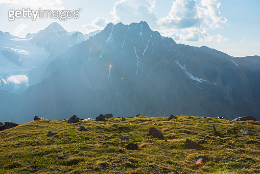 Awesome mountain scenery with big sharp stones in green grass near ...
