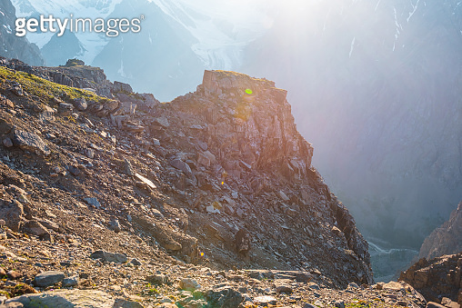 Sunny mountain view from cliff at very high altitude. Scenic alpine ...