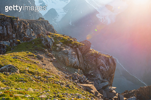 Sunny mountain view from cliff at very high altitude. Scenic alpine ...