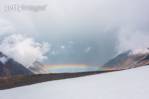 Minimalist alpine landscape with vivid rainbow. Scenic minimal view ...
