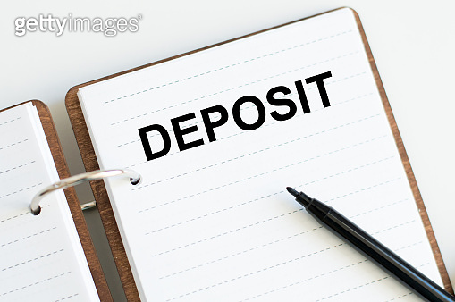 Deposit text on a notebook on the table, business concept (1401121888 ...