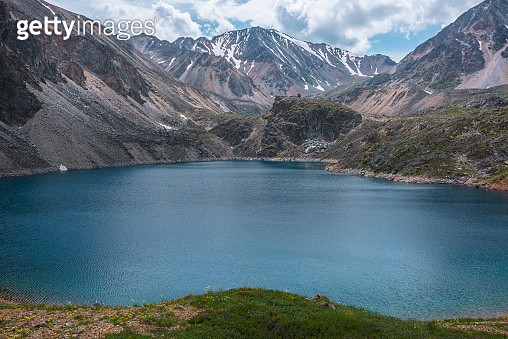 Deep mountain lake of phantom blue color among sharp rocks and high ...