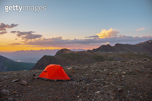 Scenic alpine landscape with tent at very high altitude with view to ...