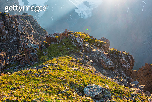 Sunny mountain view from cliff at very high altitude. Scenic alpine ...
