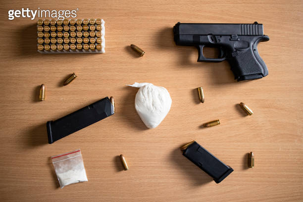 Drugs paraphernalia, gun, bullets and cocain narcotics packaging ready ...