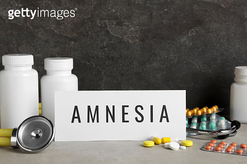 Card with word Amnesia, drugs and stethoscope on light grey table 이미지 ...