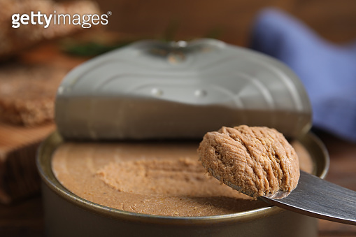 Open tin can with meat pate and knife on table, closeup (1417540248 ...