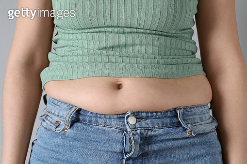 Woman Wearing Tight Clothes On Light Grey Background Closeup