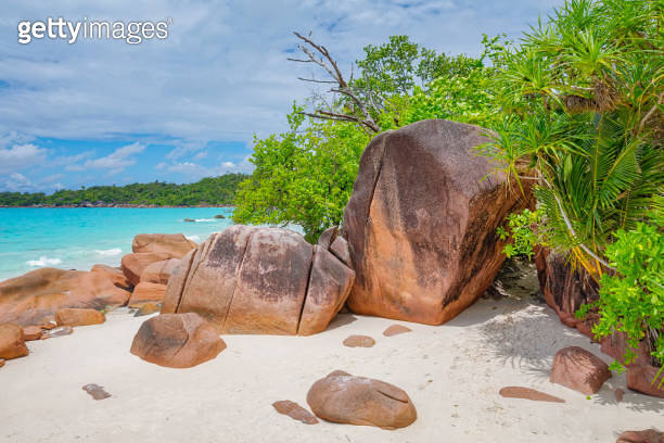 Tropical beach Anse Lazio with typical mighty granite rock formations ...