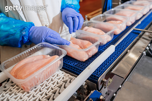 Meat processing,food industry.Packing of meat slices in boxes ,conveyor ...