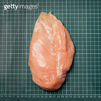 Fresh chicken fillet on line board. Raw chicken fillet meat without ...