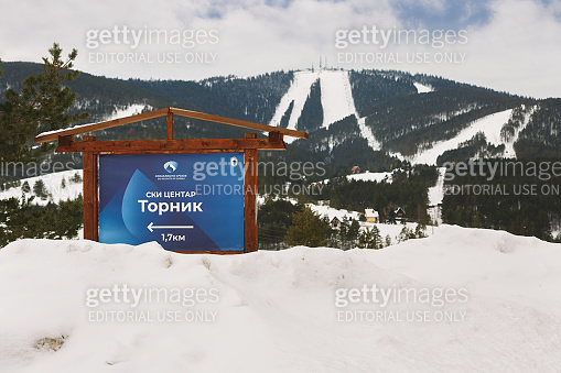 Ski Hill Resort Sign. Ski Resort Tornik is seen behind a road sign for ...