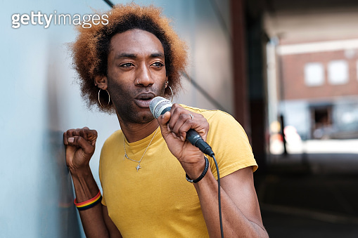 A young non-binary singer is performing in a street of London. 이미지 ...
