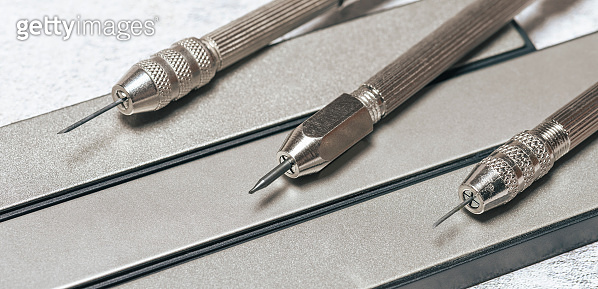 Set of sharp scrapers on diamond whetstones for sharpening. Mechanical ...