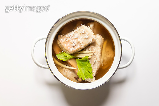 Pot of soup with sea bass fish and herb, healthy meal. Overview shot ...